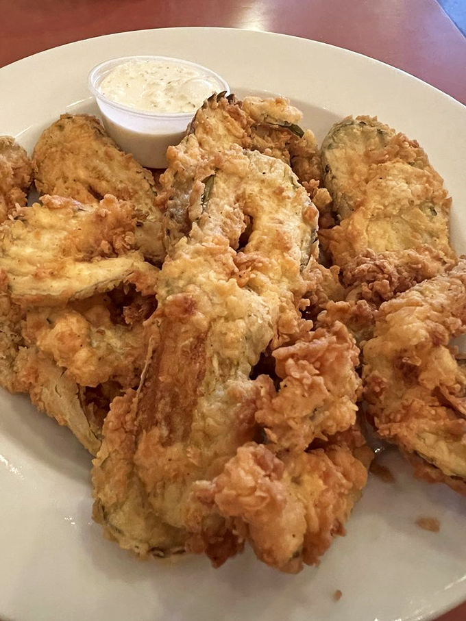 Fried pickles with a golden crunch that would make even pickle skeptics reconsider their life choices. Ranch dipping sauce seals the deal.