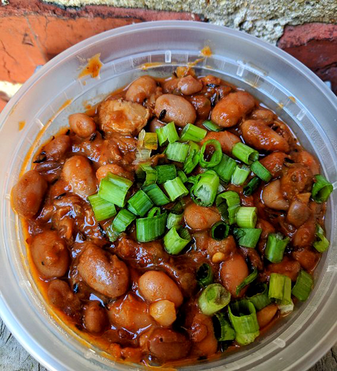 Frijoles de charro&mdash;where beans transcend their humble origins. Those green onions aren't just garnish; they're the perfect finishing touch to this smoky pool of flavor.