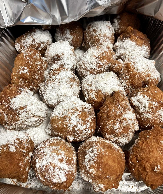 Sugar-dusted fritters that look like tiny powdered pillows of fried dough happiness, because sometimes you need dessert before dinner.
