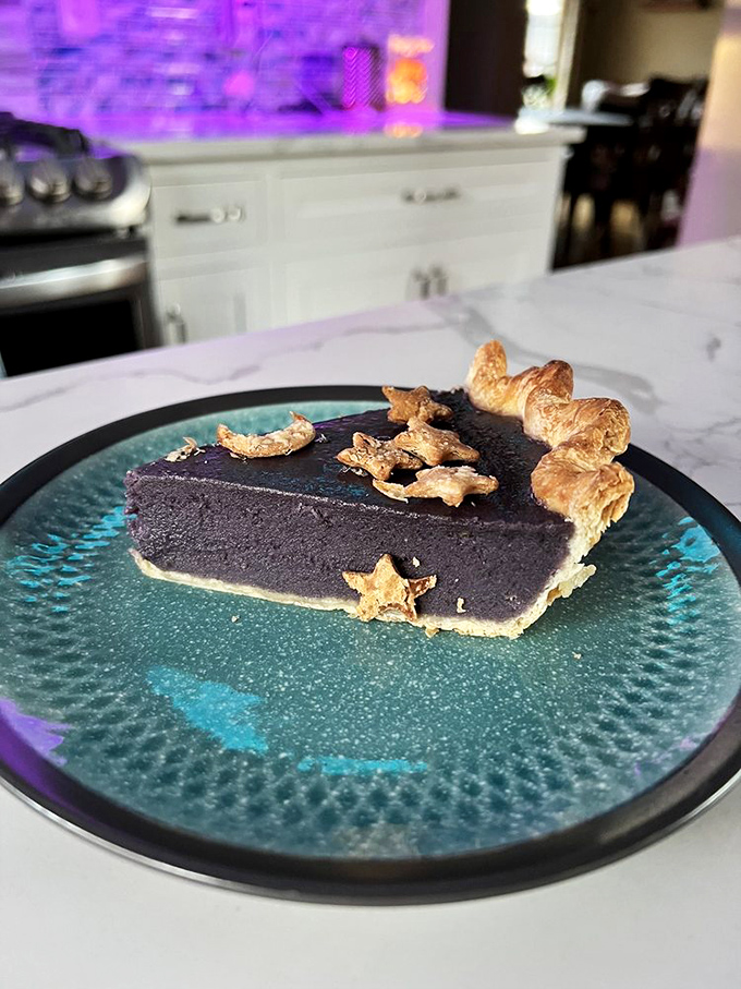 This slice of Galaxy Pie doesn't just look otherworldly&mdash;its deep purple filling and star-shaped pastry garnishes make dessert feel like an astronomical event.