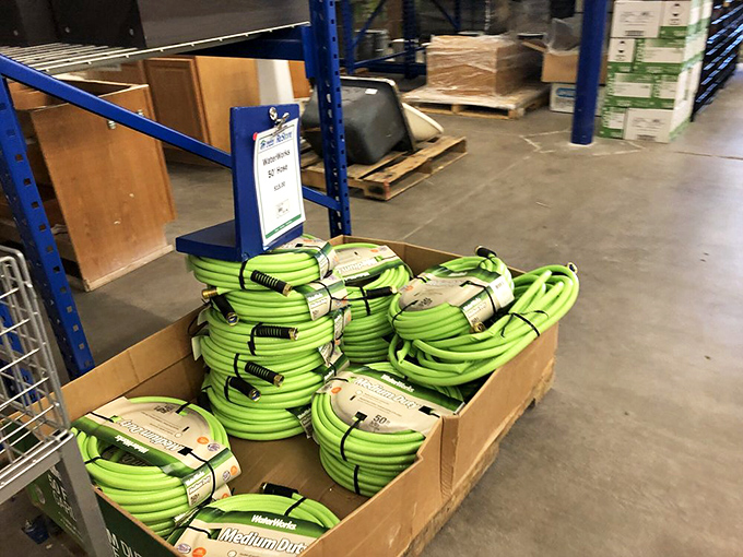 Garden hoses coiled like bright green pythons, ready to bring life to desert yards. New with tags but without the painful price tag.