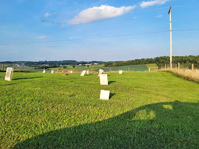Simple stone markers stand against an endless horizon, a poignant reminder of the Amish belief in humility extending beyond life itself.