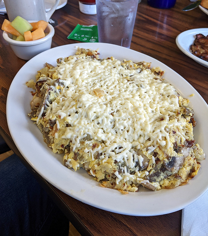 The Greek Hobo isn't just a scramble—it's an edible jigsaw puzzle where cheese is the glue holding this beautiful mess together.