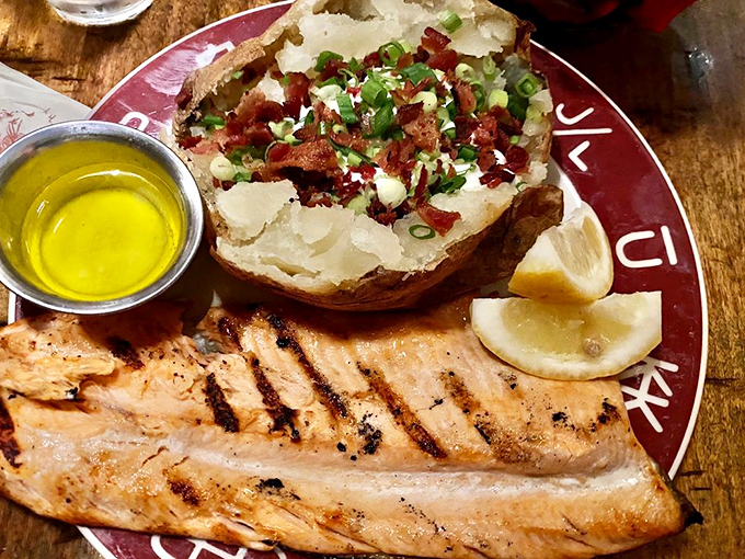 Grilled salmon that tastes like it just swam upstream through butter, paired with a potato that's living its best life.