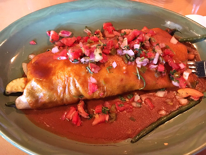 A burrito stuffed so generously it might need its own zip code, topped with vibrant pico de gallo.