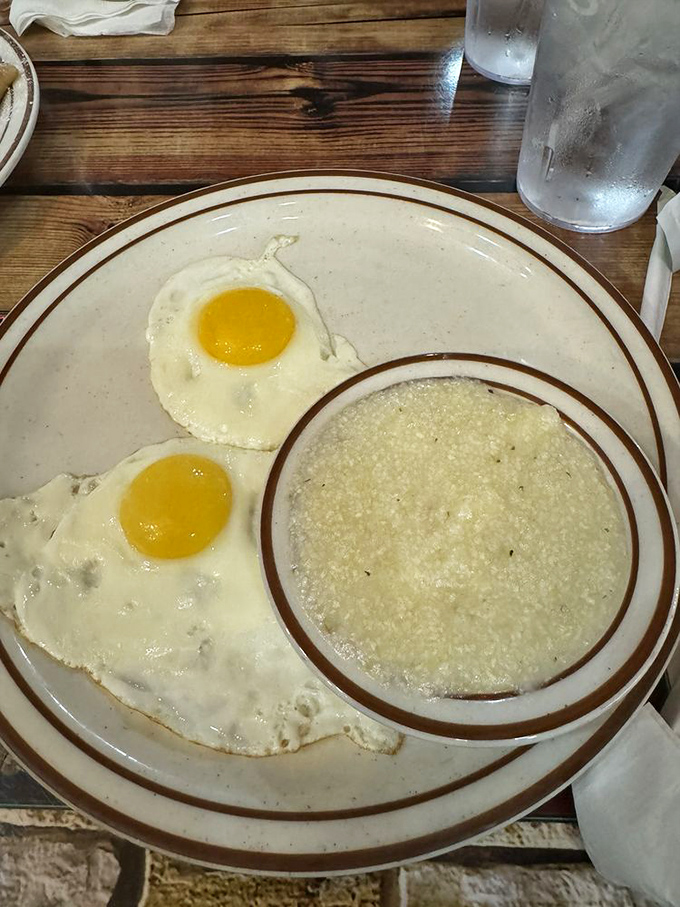 Sunny-side up eggs with a side of grits&mdash;a Southern breakfast duet performing their greatest hits on a simple white plate.