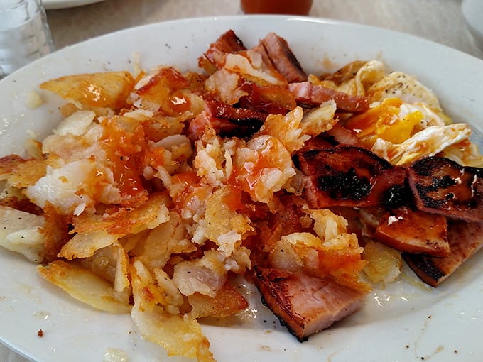 A breakfast symphony of crispy potatoes, savory ham, and eggs. Like a morning playlist where every track is a greatest hit.