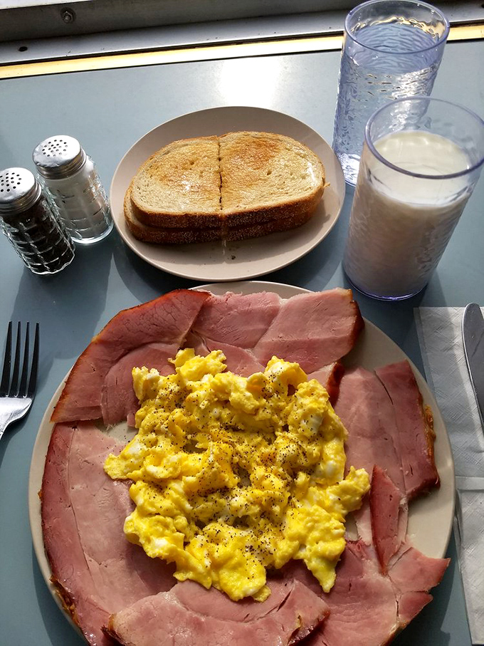 The breakfast of Detroit champions: scrambled eggs surrounded by a ham fortress, with buttered toast standing by for dipping duty.
