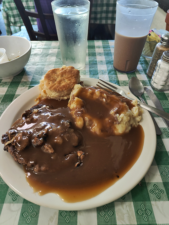 Comfort food royalty: hamburger steak and mashed potatoes swimming in gravy that could solve world peace.