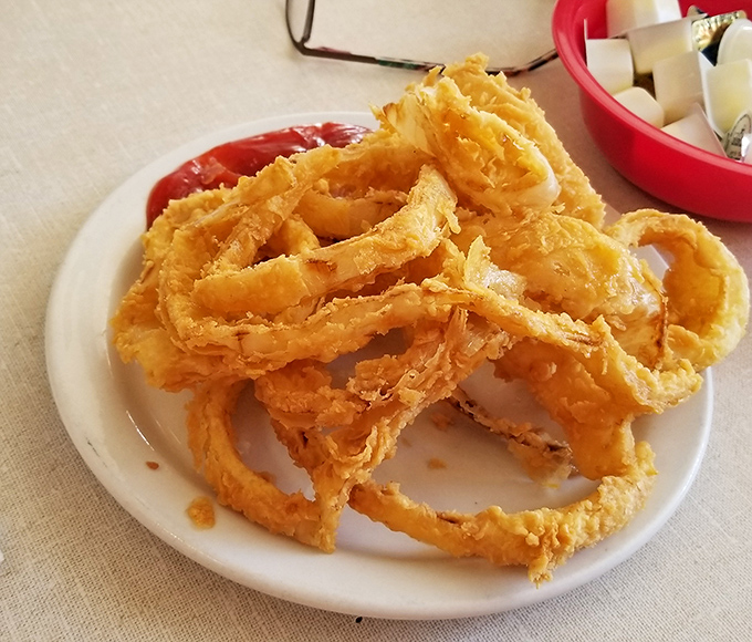 These aren't just onion rings—they're golden halos of crispy perfection that make you wonder why anyone would ever settle for the frozen kind.