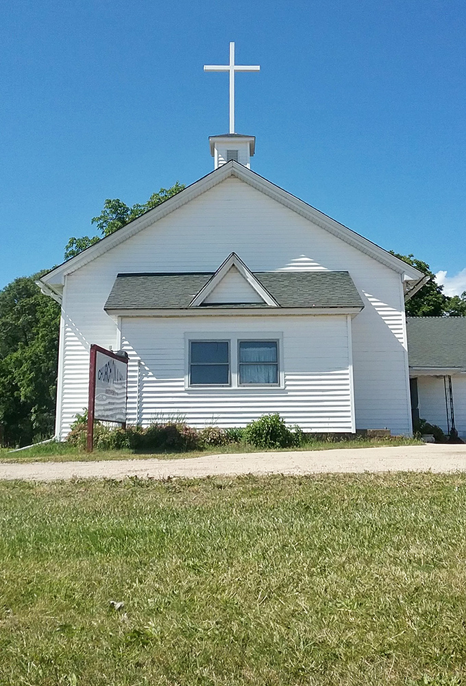 White clapboard churches like this remind you when America knew how to do simple beauty without overthinking every design element.