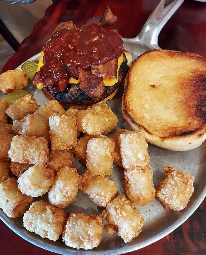 Burger architecture at its finest &ndash; melty cheese, bacon, and house sauce creating a masterpiece that requires both hands and extra napkins.