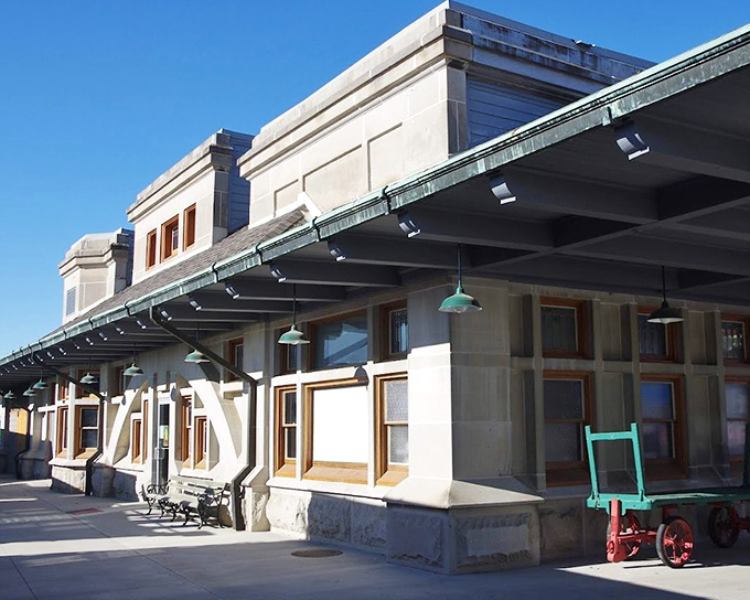 Sunlight bathes the historic depot's platform, where vintage railway equipment hints at stories from Indiana's transportation heritage.