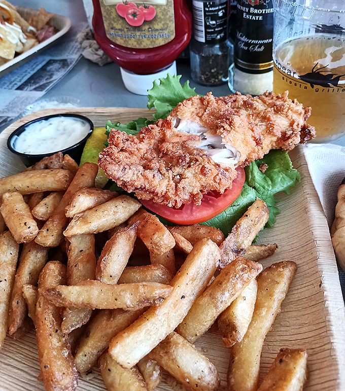 That crispy hogfish sandwich with seasoned fries could make a vegetarian seriously reconsider their life choices temporarily.
