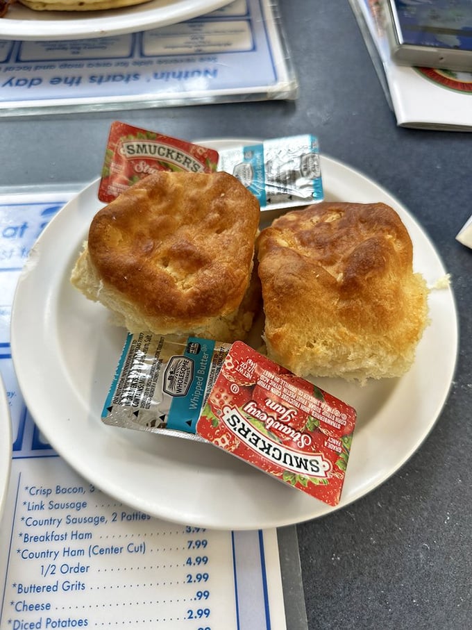These golden-topped biscuits aren't just side items &ndash; they're the supporting actors that often steal the show. Smuckers packets stand ready for their sweet supporting role.