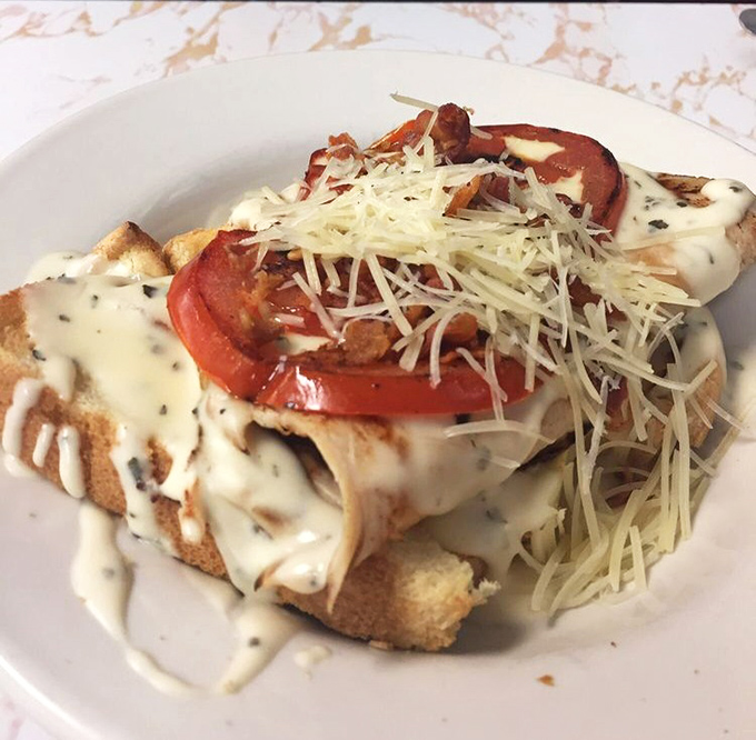 The Kentucky Hot Brown &ndash; an open-faced masterpiece that proves cheese sauce and bacon can elevate any dish from good to "where has this been all my life?"