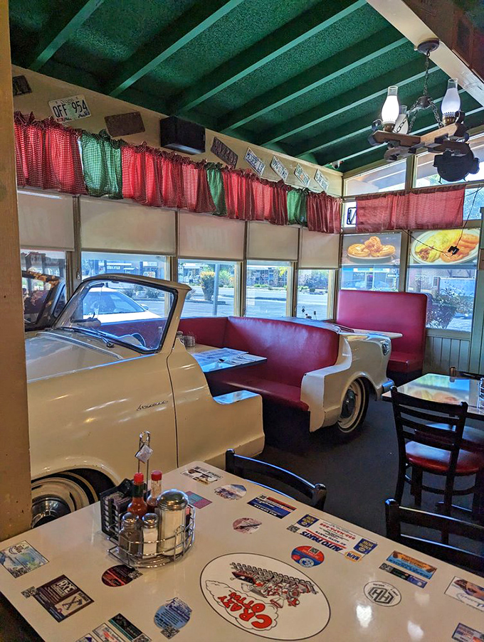 Not just a booth&mdash;a time capsule with red vinyl seating and checkered curtains. The vintage car seating area proves Crazy Otto's knows eating is as much about atmosphere as appetite.