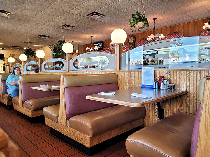 Globe lights and wood paneling create that timeless diner vibe where everything feels familiar and comforting at once.