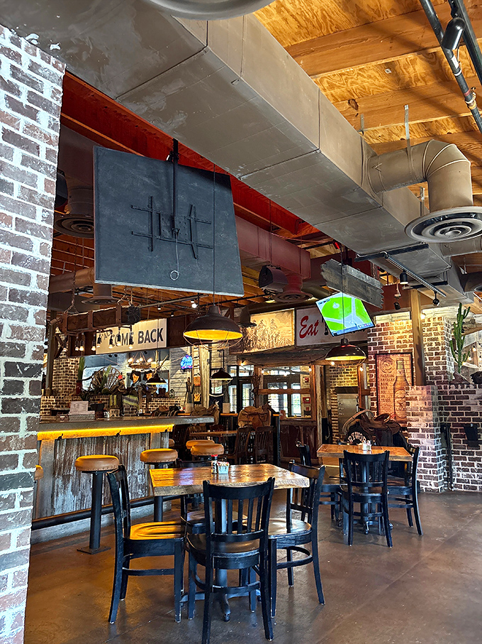 The bar area's exposed ductwork, brick walls, and rustic wood create that perfect "fancy enough to impress, casual enough to relax" vibe.