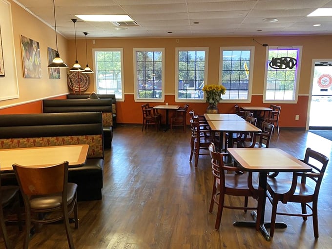 Warm wood tones and natural light create a dining space where conversations flow as easily as the mango lassi.