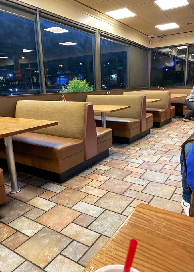 Booths designed for comfort, not Instagram aesthetics. The nighttime ambiance says, "Stay awhile, the fries are worth it."