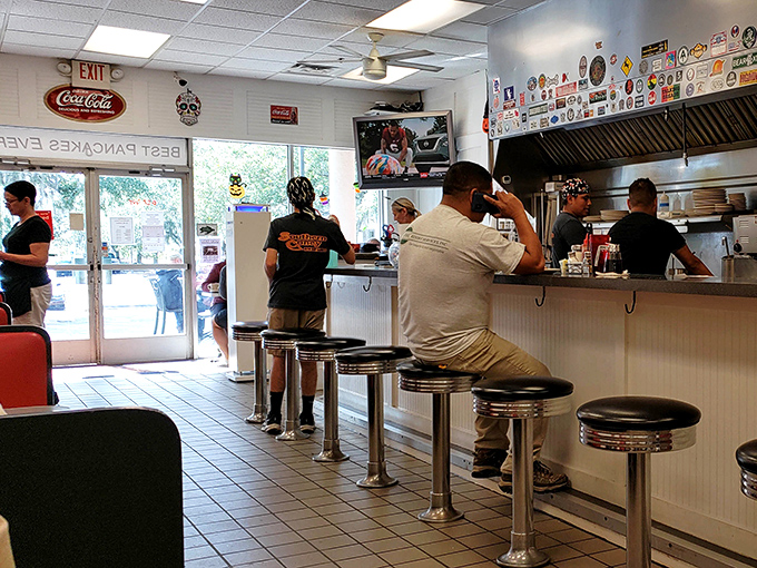 The counter seating offers front-row tickets to the breakfast show, where short-order cooking becomes a choreographed dance of spatulas and sizzle.