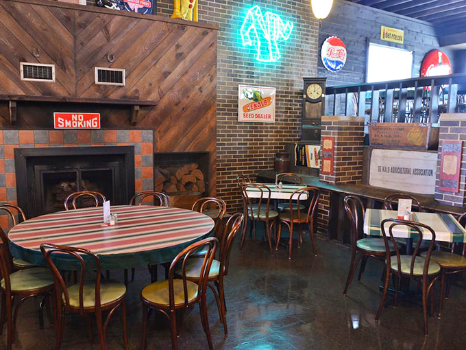The dining room's rustic charm extends to the fireplace corner, where vintage signs and cozy tables invite you to settle in and stay awhile.