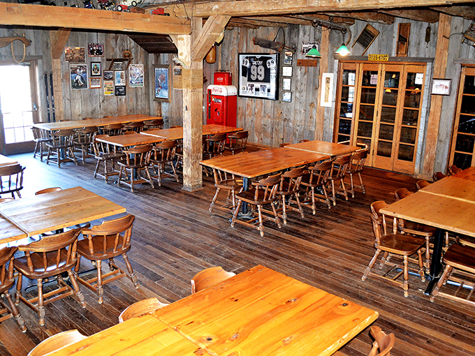 Honey-colored wooden tables and chairs fill this dining area where rustic barn walls create the perfect backdrop for comfort food conversations.