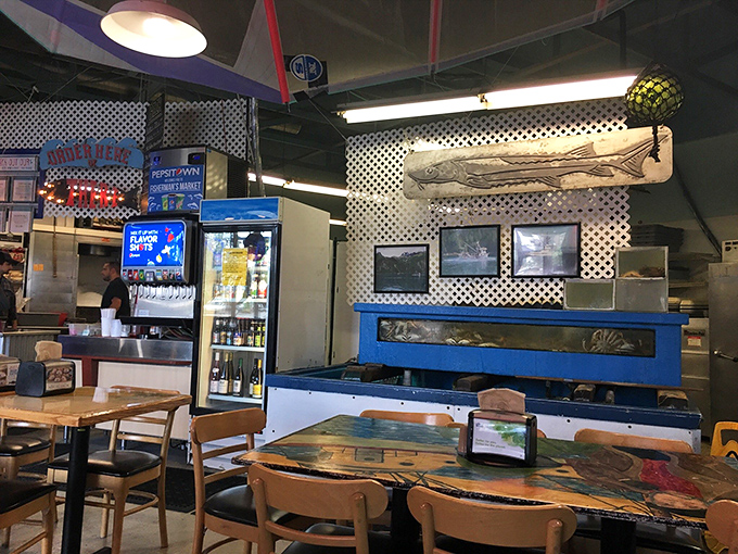 Maritime meets modern in the dining area, where fishing artifacts and comfortable seating create the perfect backdrop for seafood feasting.