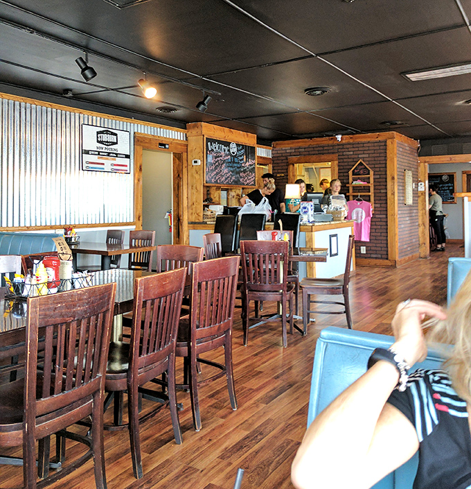 The dining room buzzes with conversation and anticipation, wood and metal creating that perfect "discovered gem" atmosphere.