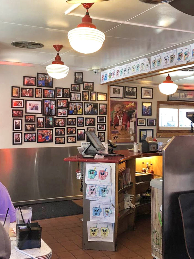 The wall of fame doesn't just show who's been here&mdash;it shows who knows what matters. Decades of memories hang alongside vintage diner lights.