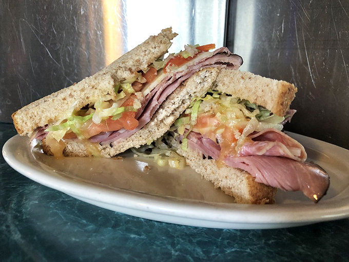 This isn't just a sandwich; it's an architectural marvel of ham, veggies, and bread that would make any deli owner weep with joy.