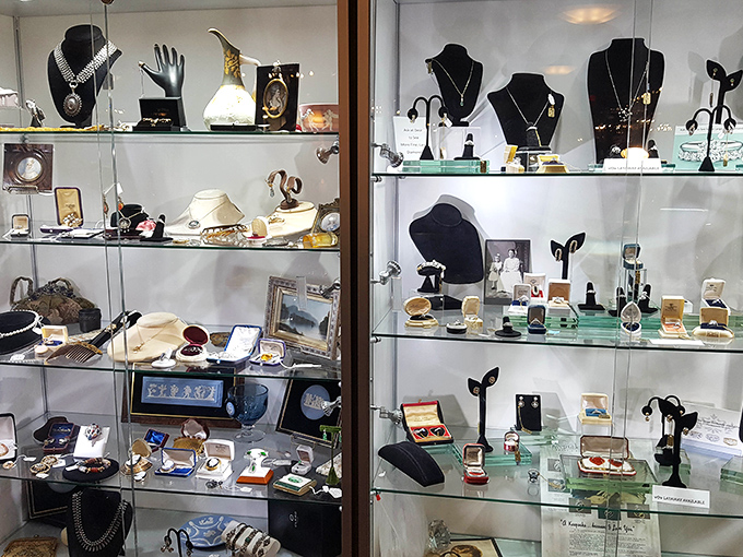 The storefront reveals its treasures with a simple promise: "Fine Consignments." Store hours posted for those who plan their treasure hunting expeditions accordingly.