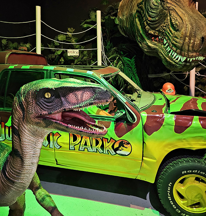 Life finds a way—especially at this Jurassic Park vehicle display. That velociraptor looks hungry for more than just photo opportunities.