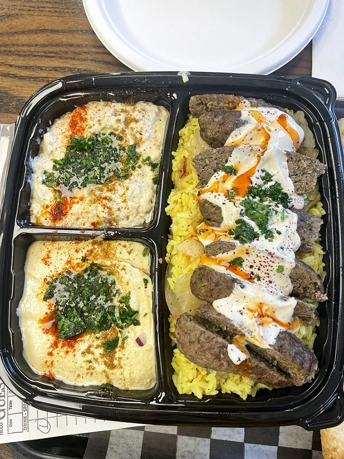 Kafta kabob over rice &ndash; where ground meat reaches its full potential through expert seasoning and perfect grilling.