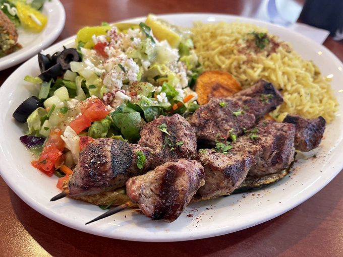 Kabobs served with rice that's fluffier than a cloud and twice as satisfying, proving skewered meat is always a good idea.