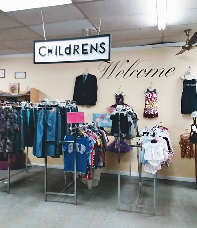 The children's section welcomes little shoppers with a cheerful sign and tiny formal wear that's seen more weddings than a justice of the peace.