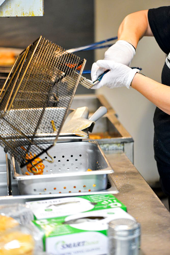 Behind every great burger is someone who knows their way around a fryer – culinary magic in action.