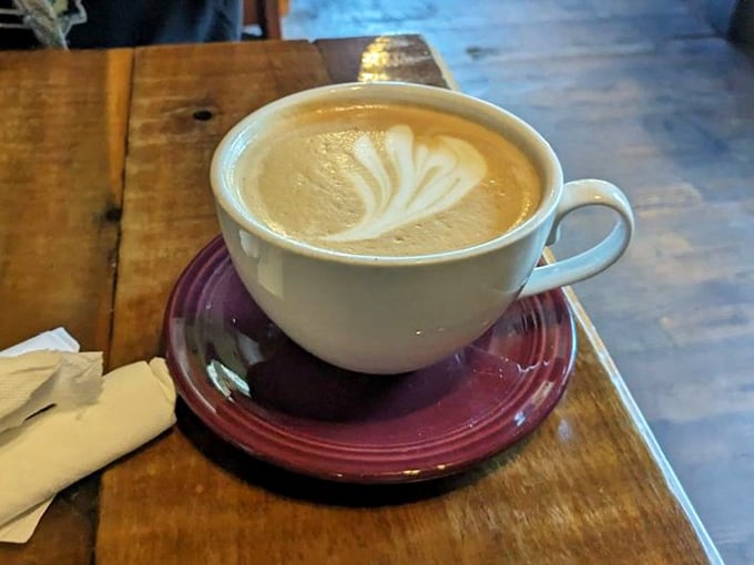 Latte art so pretty you almost don't want to drink it. Almost. The burgundy saucer adds a touch of diner-meets-caf&eacute; elegance.