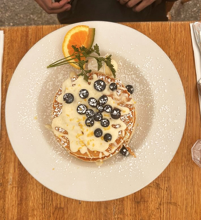 These blueberry pancakes aren't just breakfast &ndash; they're edible sunshine dusted with powdered sugar and topped with berries that pop like tiny flavor bombs.
