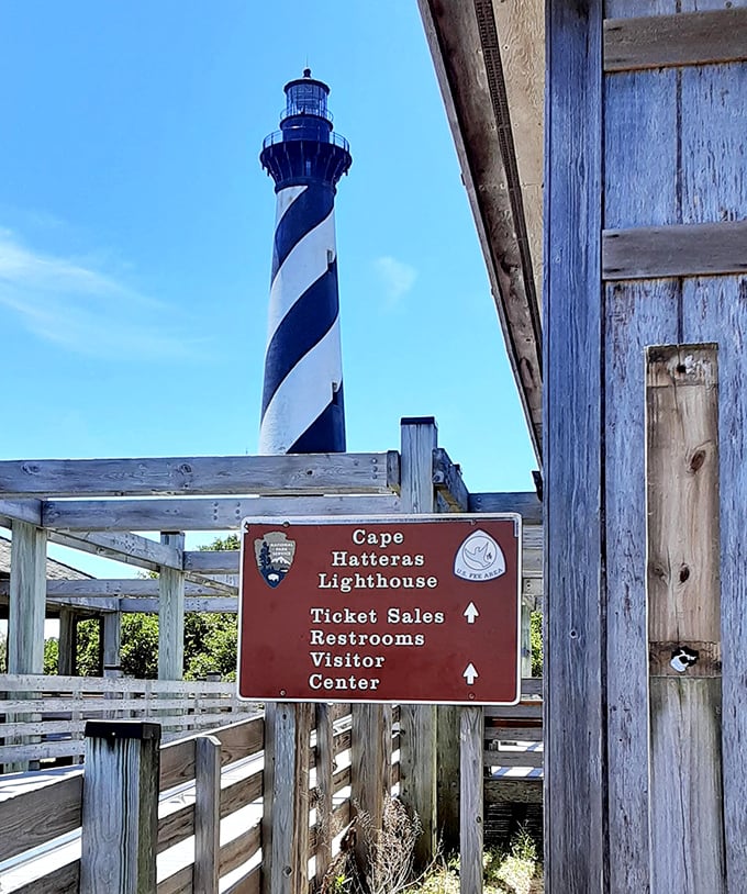 Clear signage guides visitors through the lighthouse experience, including the charming height requirement&mdash;you must be taller than the sign itself!