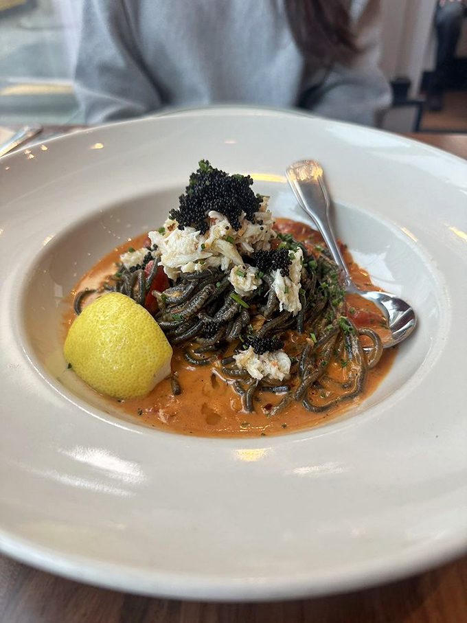 Squid ink pasta isn't just dramatic&mdash;it's a culinary plot twist. The crab and tomato cream sauce is the co-star that steals the show.