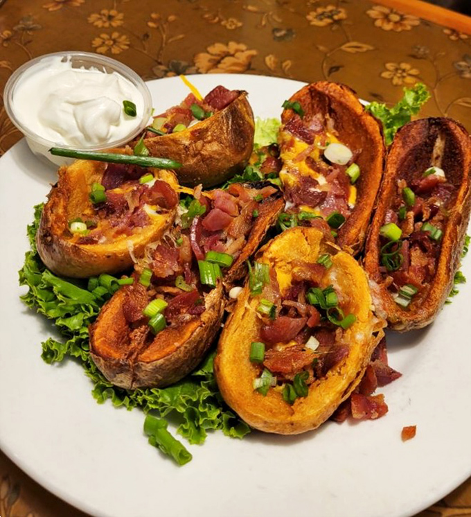 These loaded potato skins aren't messing around—crispy vessels filled with bacon, cheese, and green onions that disappear faster than you can say "just one more."