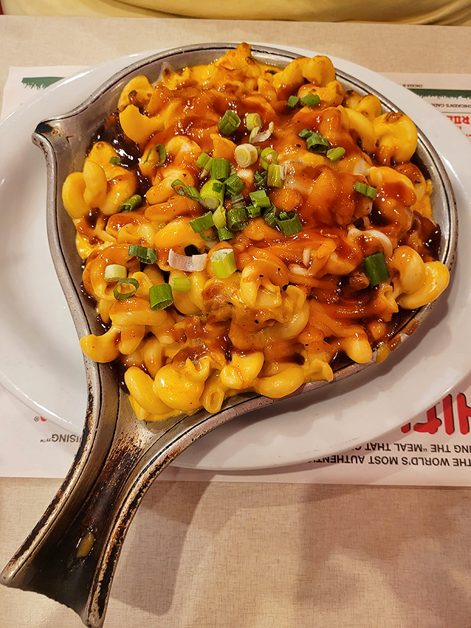 Mac and cheese that's dressed for a night out, with green onions adding a pop of color like jewelry on a perfect outfit.