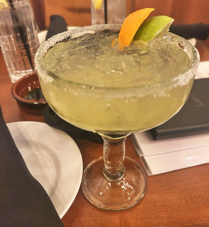 Their margarita comes with a salt rim so perfect it makes you wonder if they have a PhD in cocktail geometry.