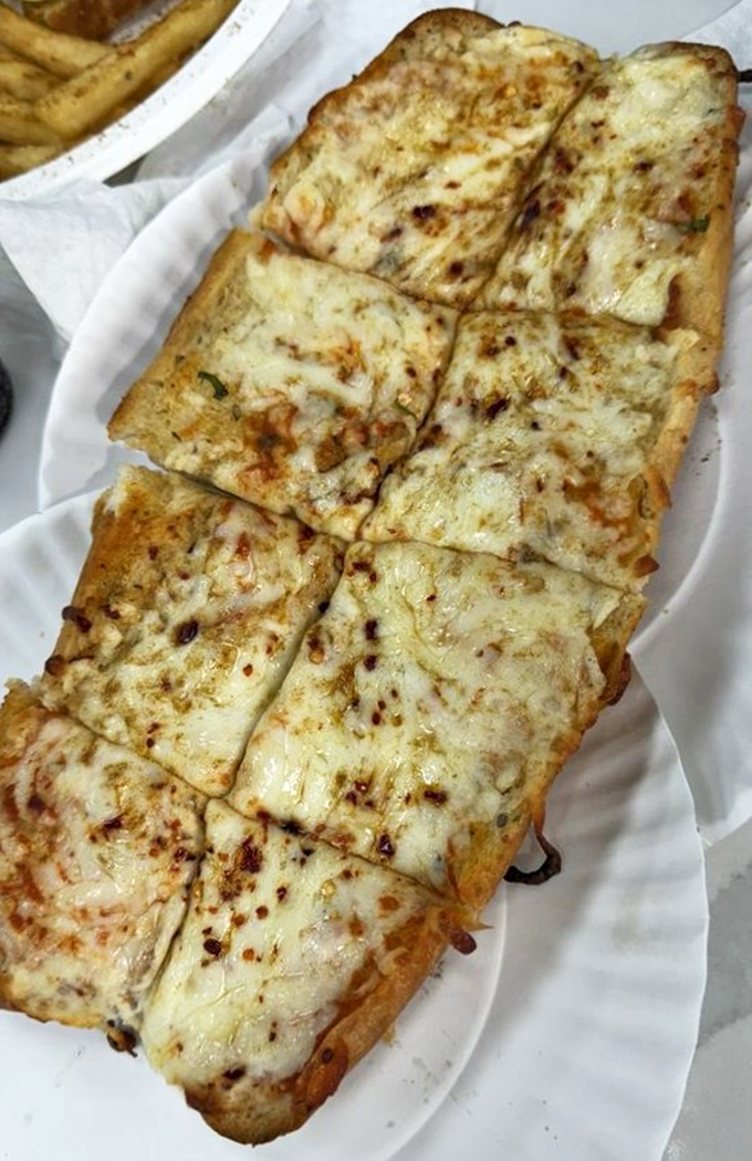 Garlic bread gets the masala treatment, proving that carbs and cheese speak a universal language that needs no translation.