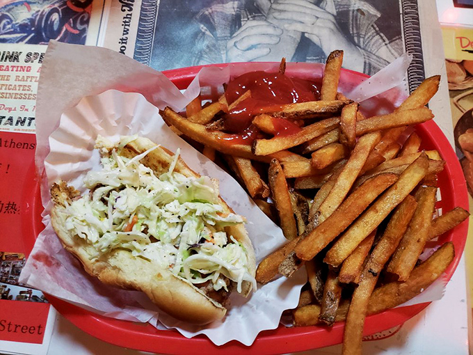 A hot dog and fries served atop what appears to be vintage burlesque artwork. Even your food gets dinner and a show at O'Betty's.