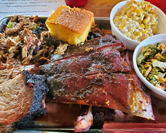 A barbecue plate that would make a vegetarian question their life choices. The ribs, pulled pork, and sides create a symphony of smoky satisfaction.