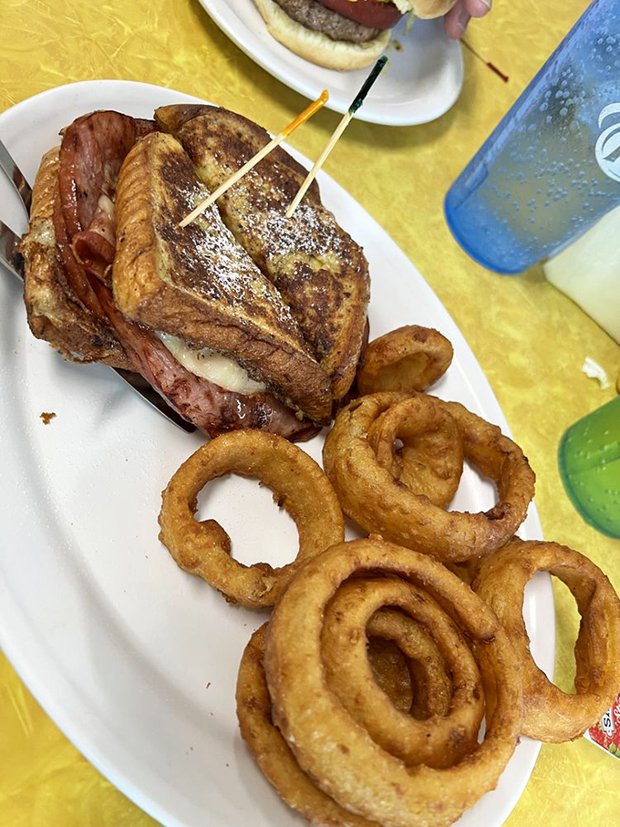 The Monte Cristo sandwich&mdash;where French toast meets ham and cheese in a powdered sugar love affair, with onion rings playing perfect wingman.