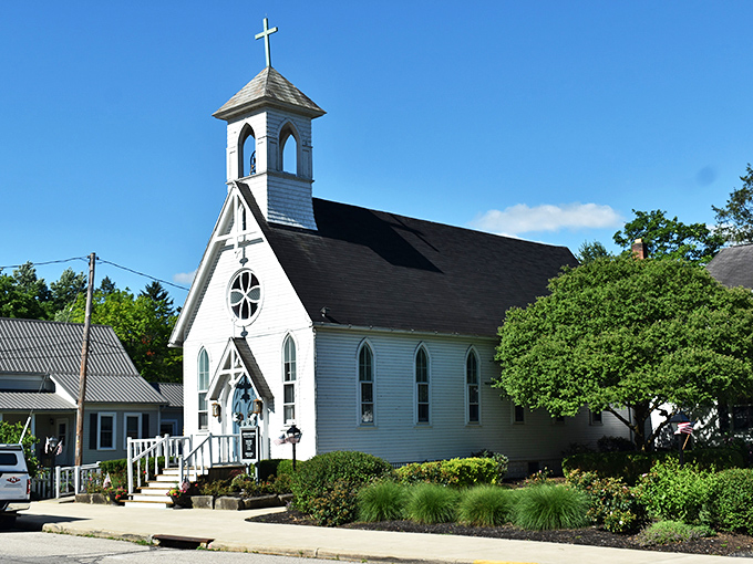 Mother of Sorrows Church gleams white against the blue Ohio sky, its simple elegance a testament to the enduring faith of generations of Peninsula residents.